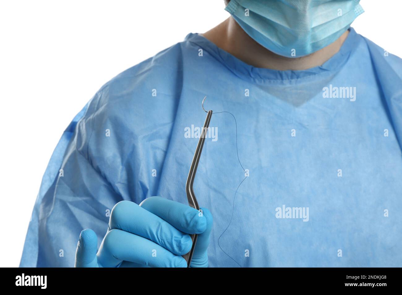 Doctor holding needle with suture thread on white background, closeup ...
