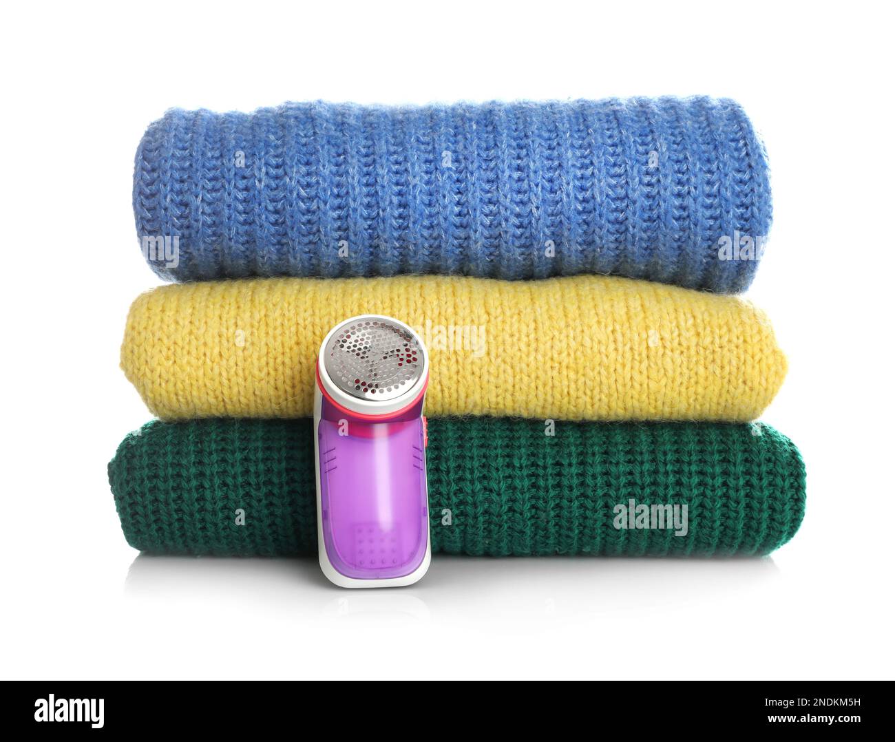 Modern fabric shaver and woolen clothes on white background Stock Photo ...