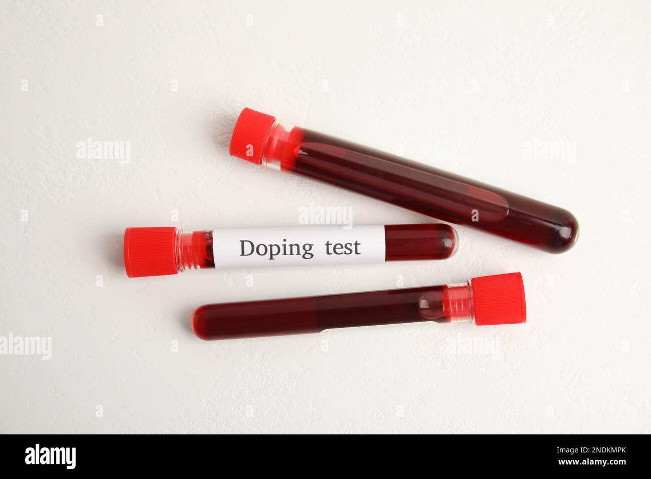 Test tubes with blood samples on beige background, flat lay. Doping ...