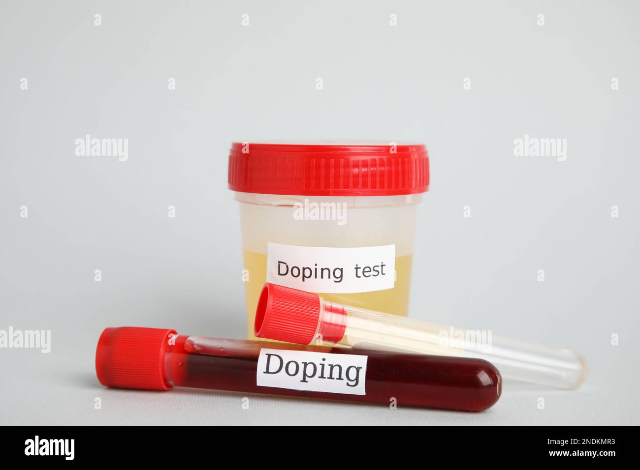 Jar and test tubes with samples on light grey background. Doping ...