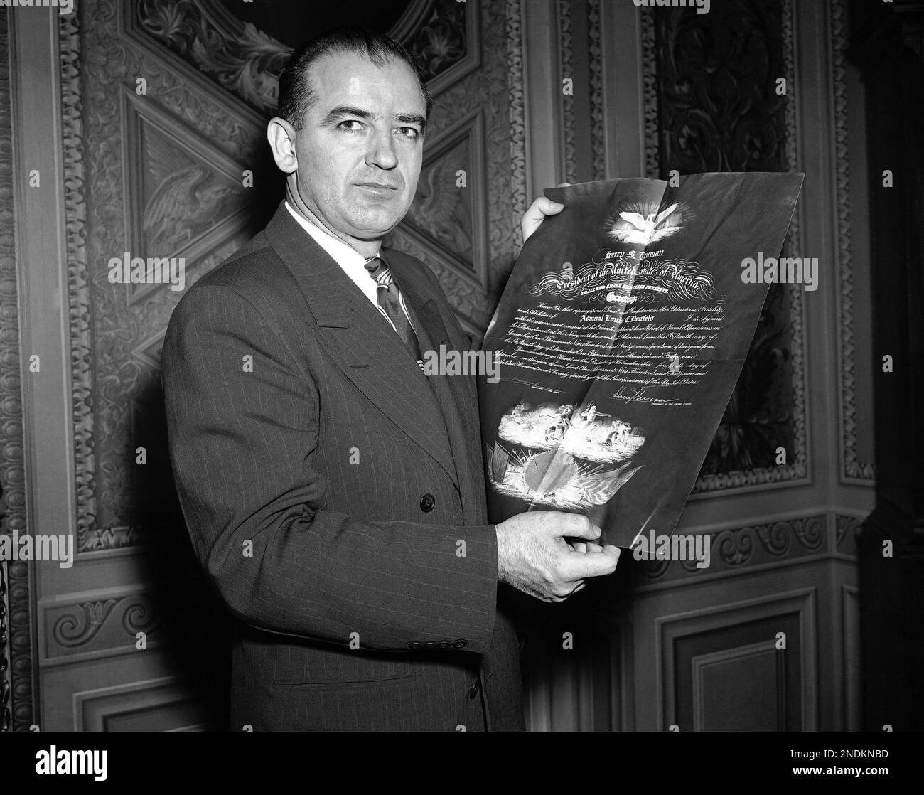 Sen. Joseph R. McCarthy (R-Wisc.) displays what he says is a copy of a ...