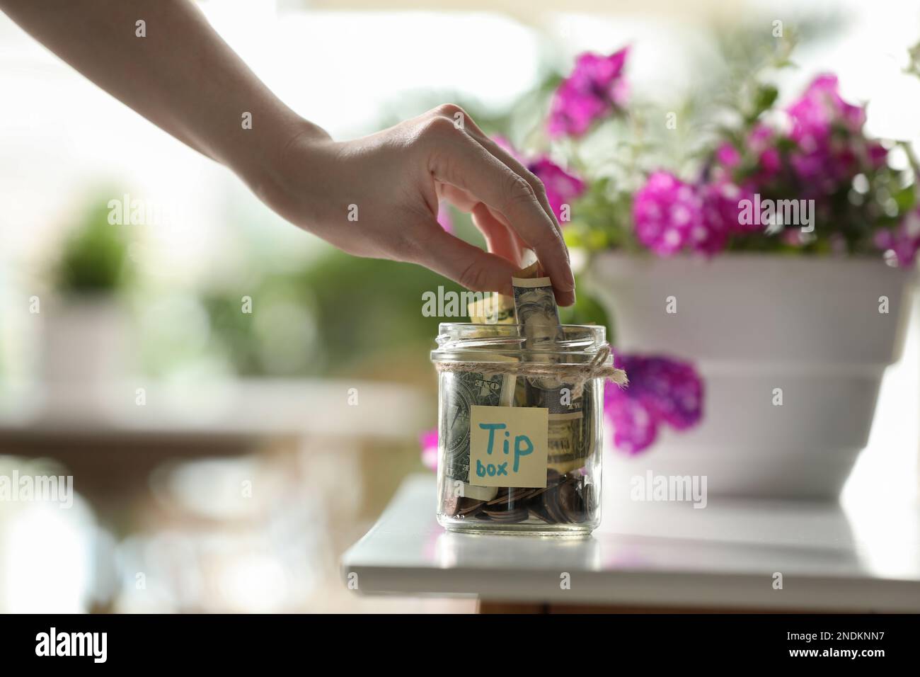 Woman putting tips glass hi-res stock photography and images - Alamy