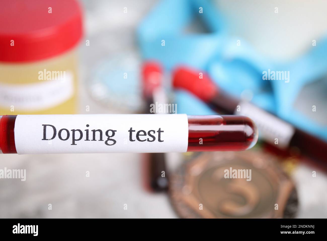Tube of blood with words Doping test on blurred background, closeup ...