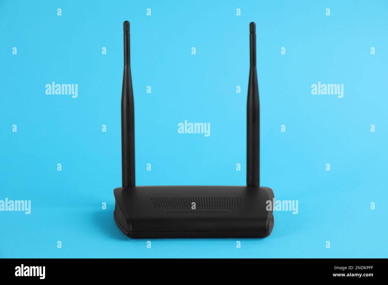 Modern Wi-Fi router on light blue background Stock Photo - Alamy