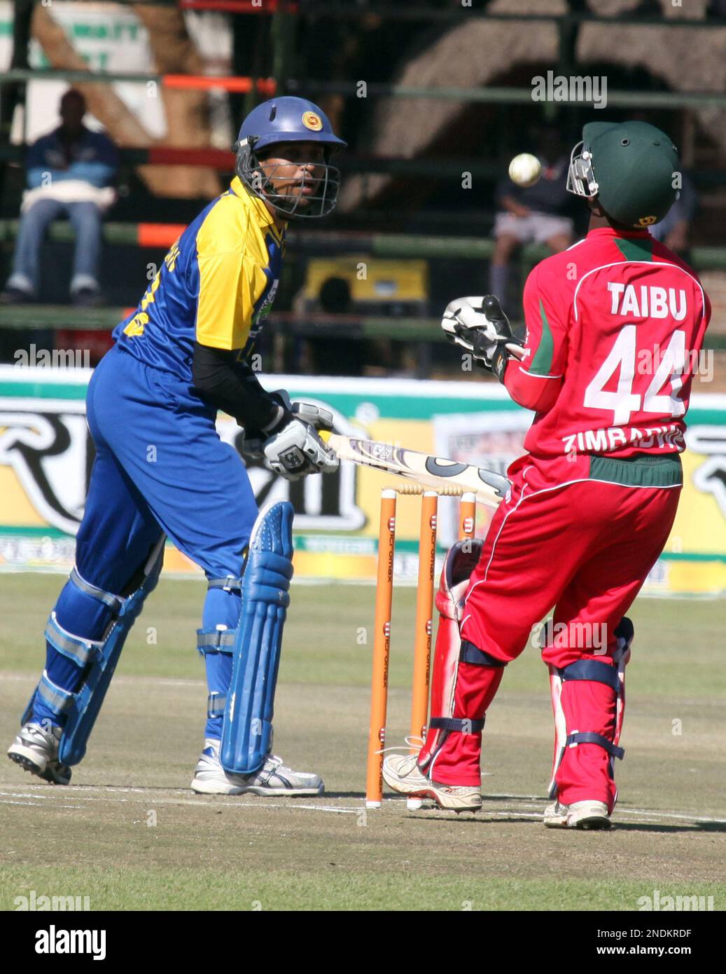 Sri Lankan batsman Tilakeratne Dilshan, left, looks on as Zimbabwean wicketkeeper Tatenda Taibu ...