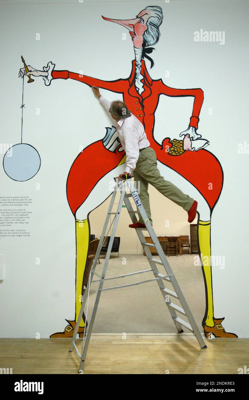 Curator and cartoonist Gerald Scarfe puts a finishing touch on a ...