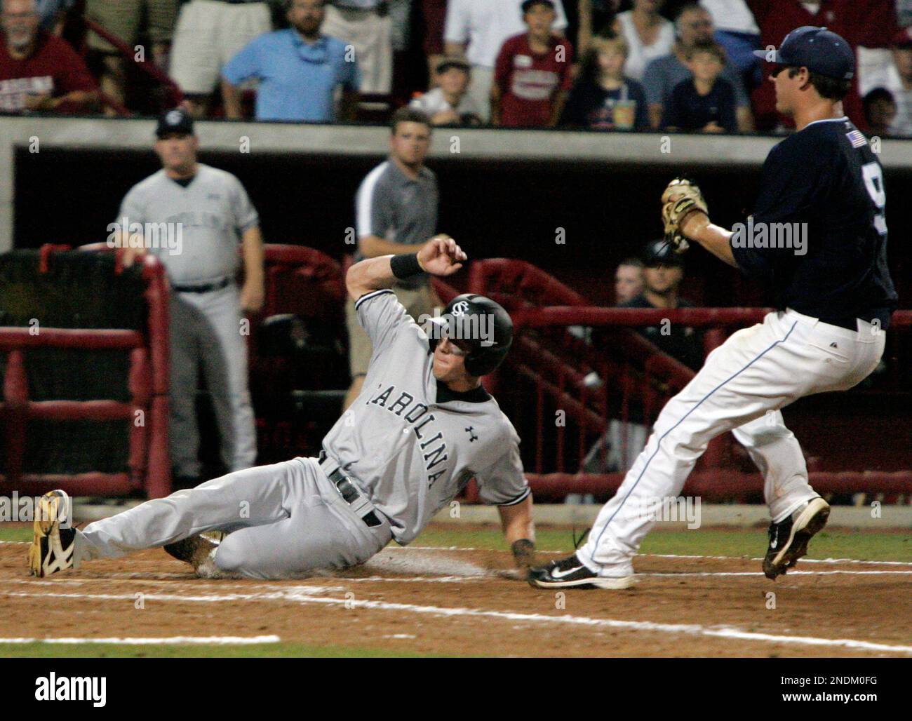 South Carolina's Evan Marzilli, left, slides into home plate and scores ...