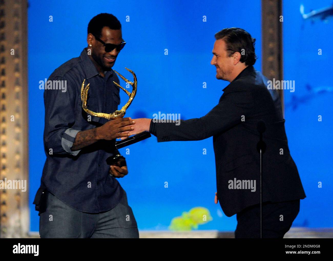 LeBron James accepts the Unstoppable Jock award from presenter Jason ...