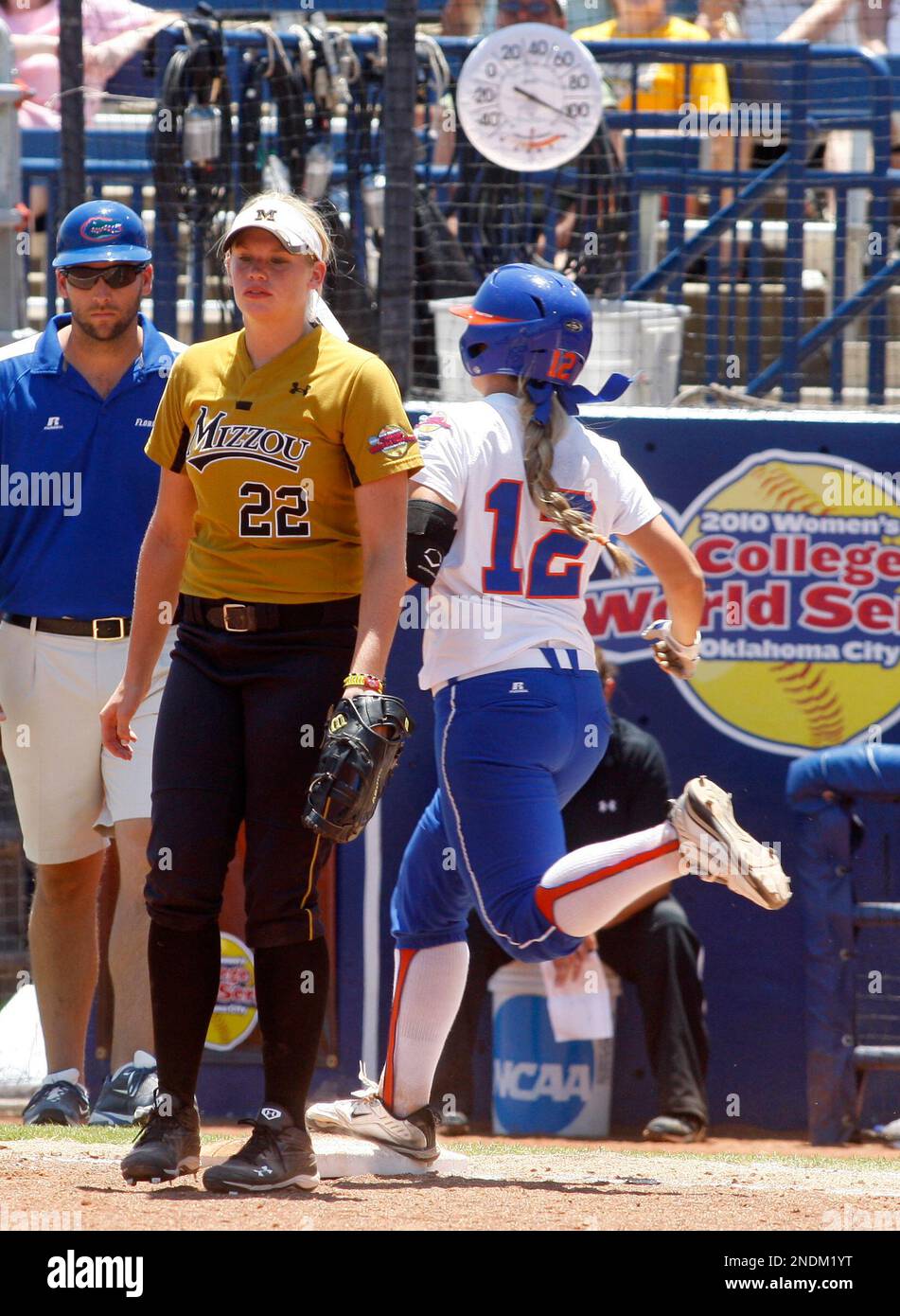 Florida's Megan Bush, right, runs to first base behind Missouri's ...