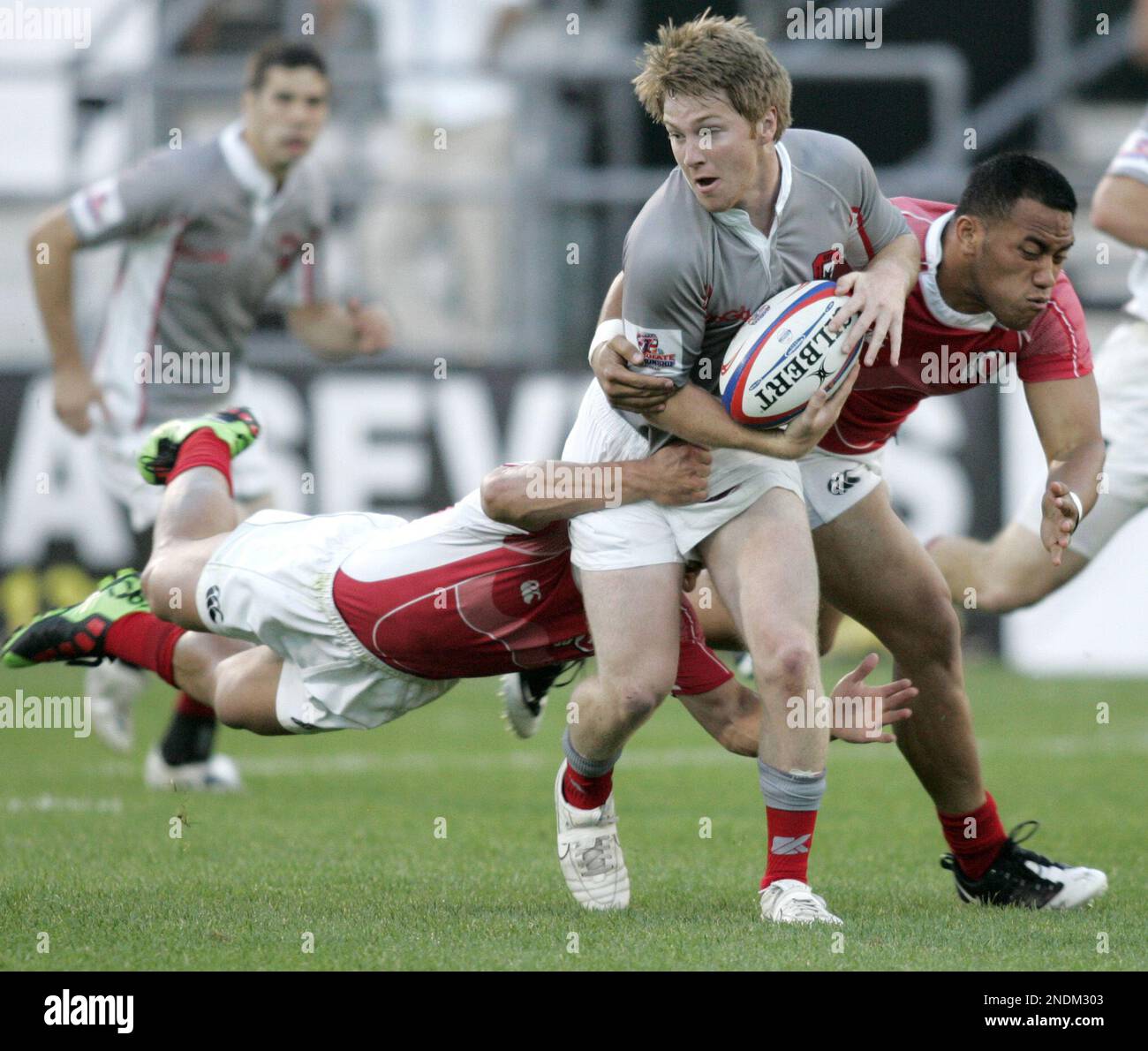 Ohio State's Kyle Harmon, center, is stopped by Utah's Don Pati, bottom ...