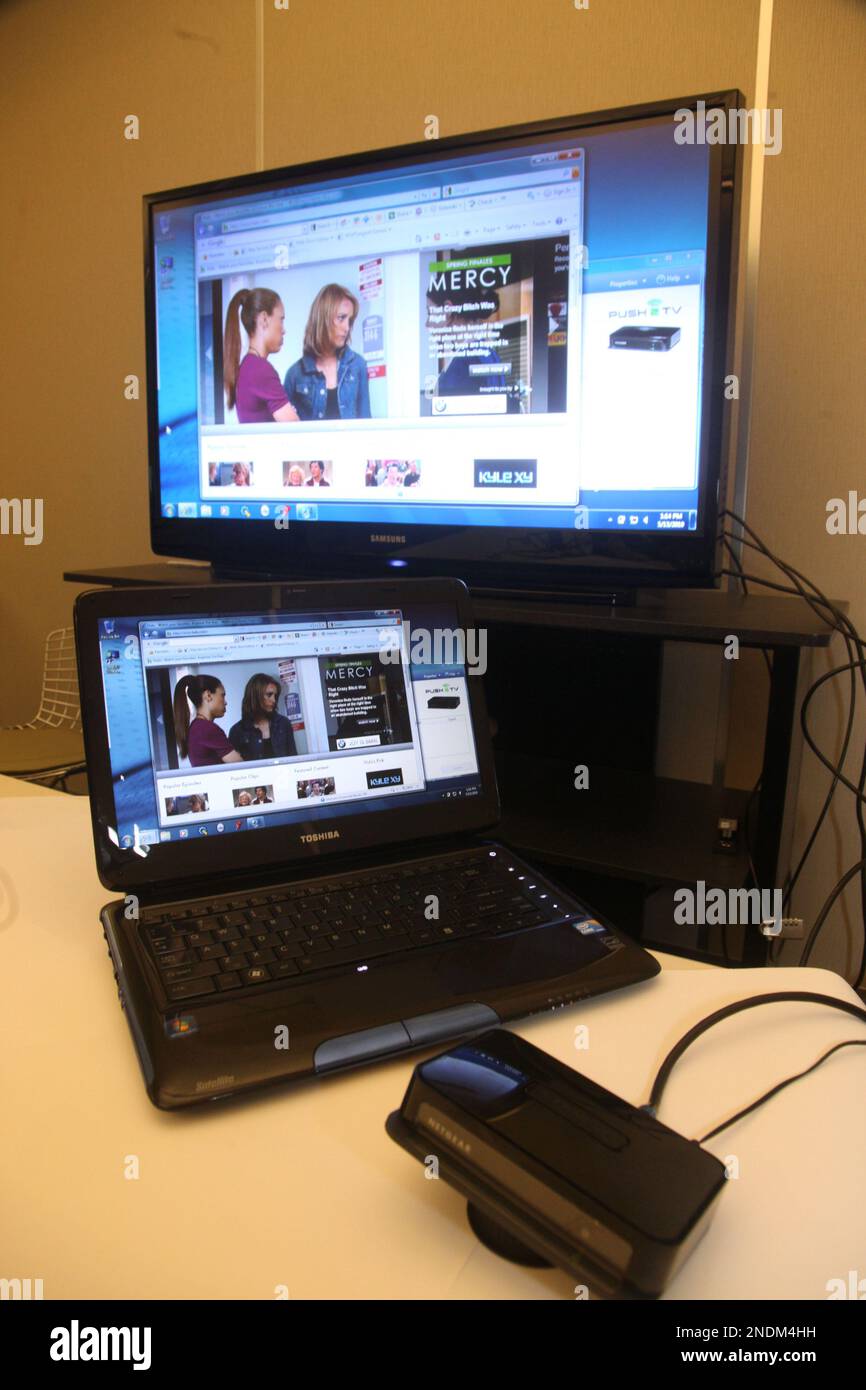 In this photo taken May 13, 2010, a Netgear box, right, connects the ...