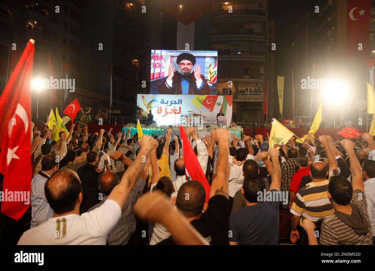 Hezbollah supporters react as leader Hassan Nasrallah speaks through a ...