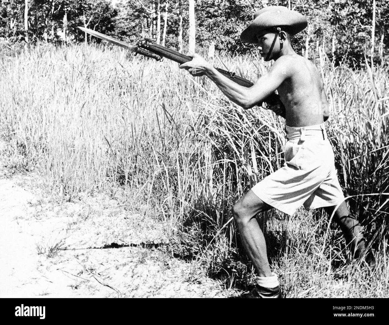 A Malay regiment recruit goes through bayonet practice after joining up ...