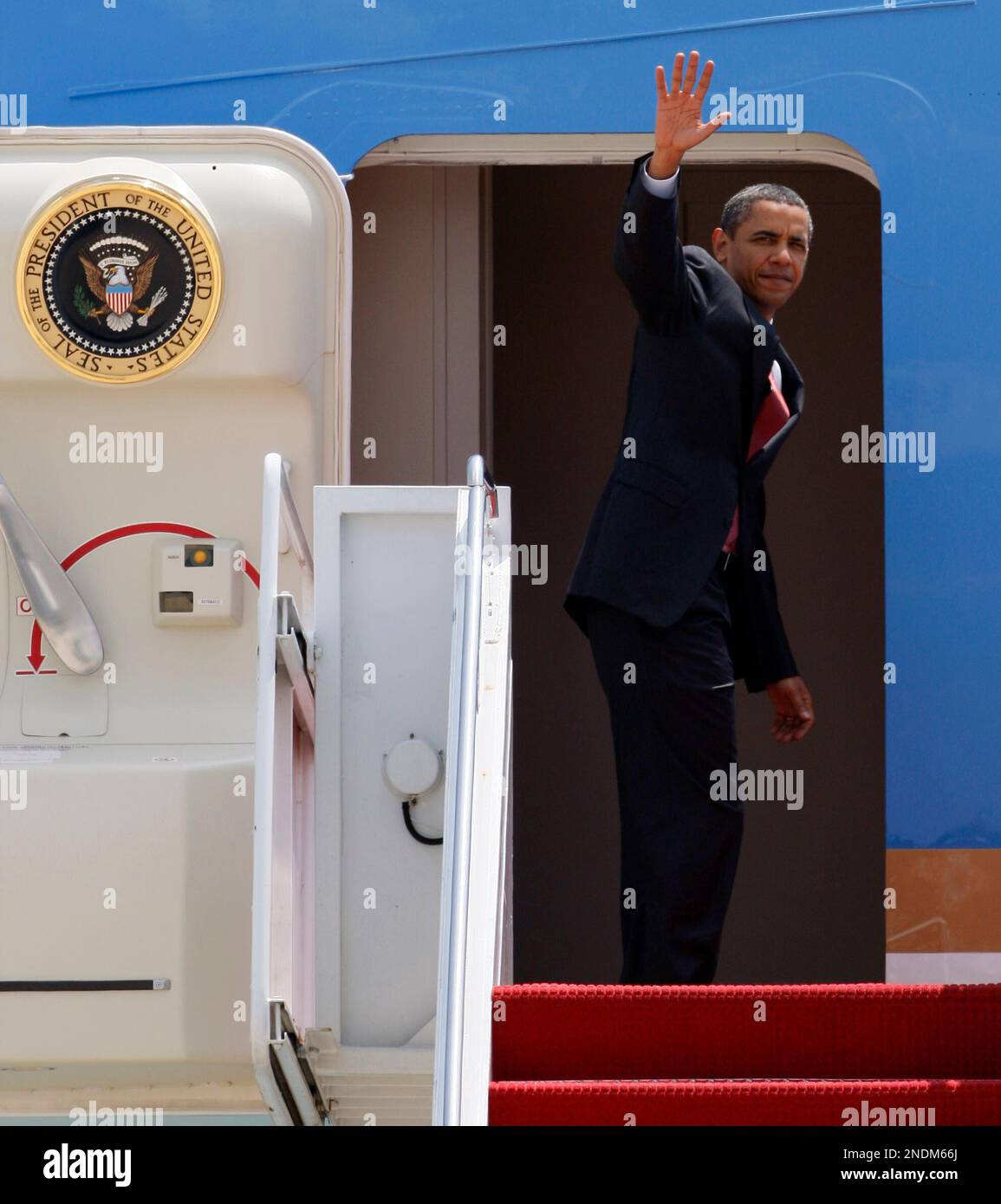 President Barack Obama waves as he boards Air Force One at Andrews Air ...