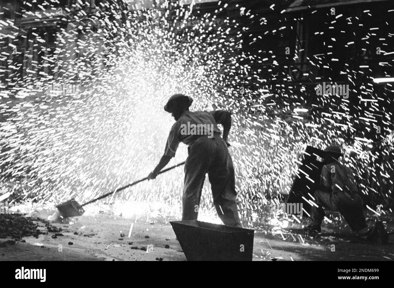 Singapore air raid wardens douse an incendiary bomb in Singapore’s raffles place on Nov. 15 ...