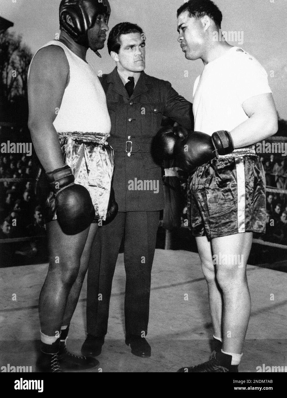 Royal Air Force Sergeant Freddie Mills, centre, gives staff Sergeant ...