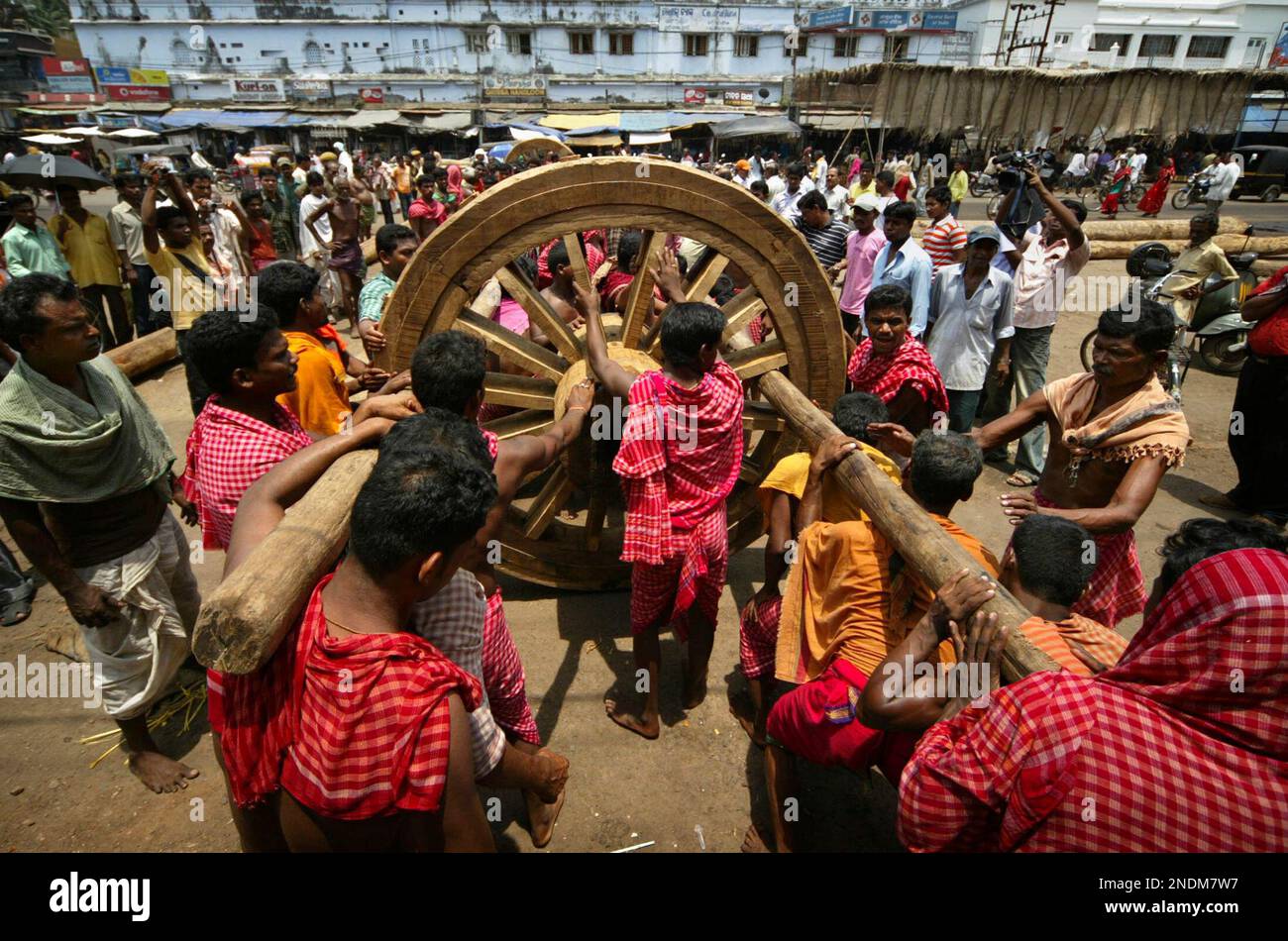 Indian traditional chariot makers make a chariot wheel ahead of the ...