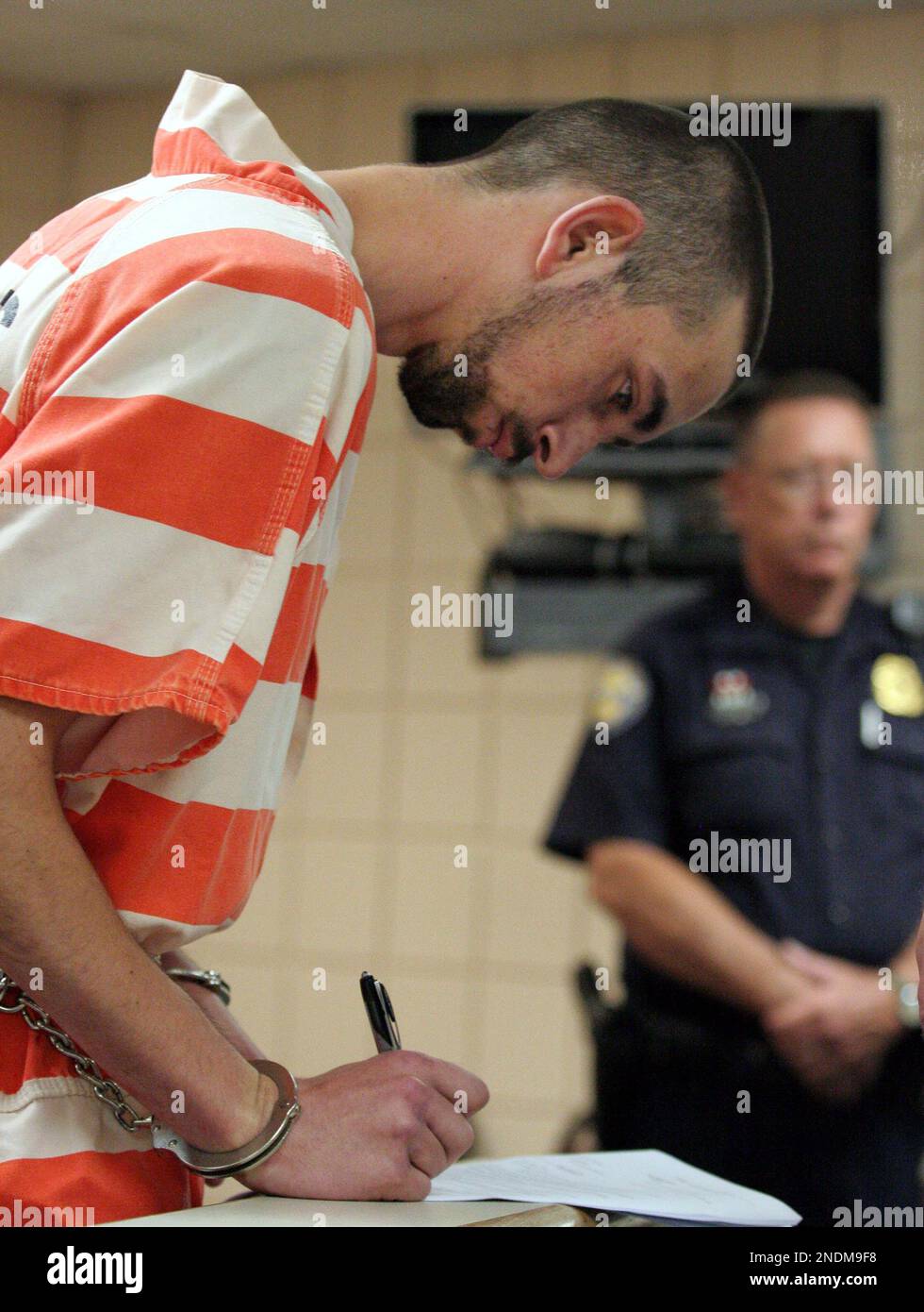 Gregory Collins, 19, signs paperwork during his first appearance in ...