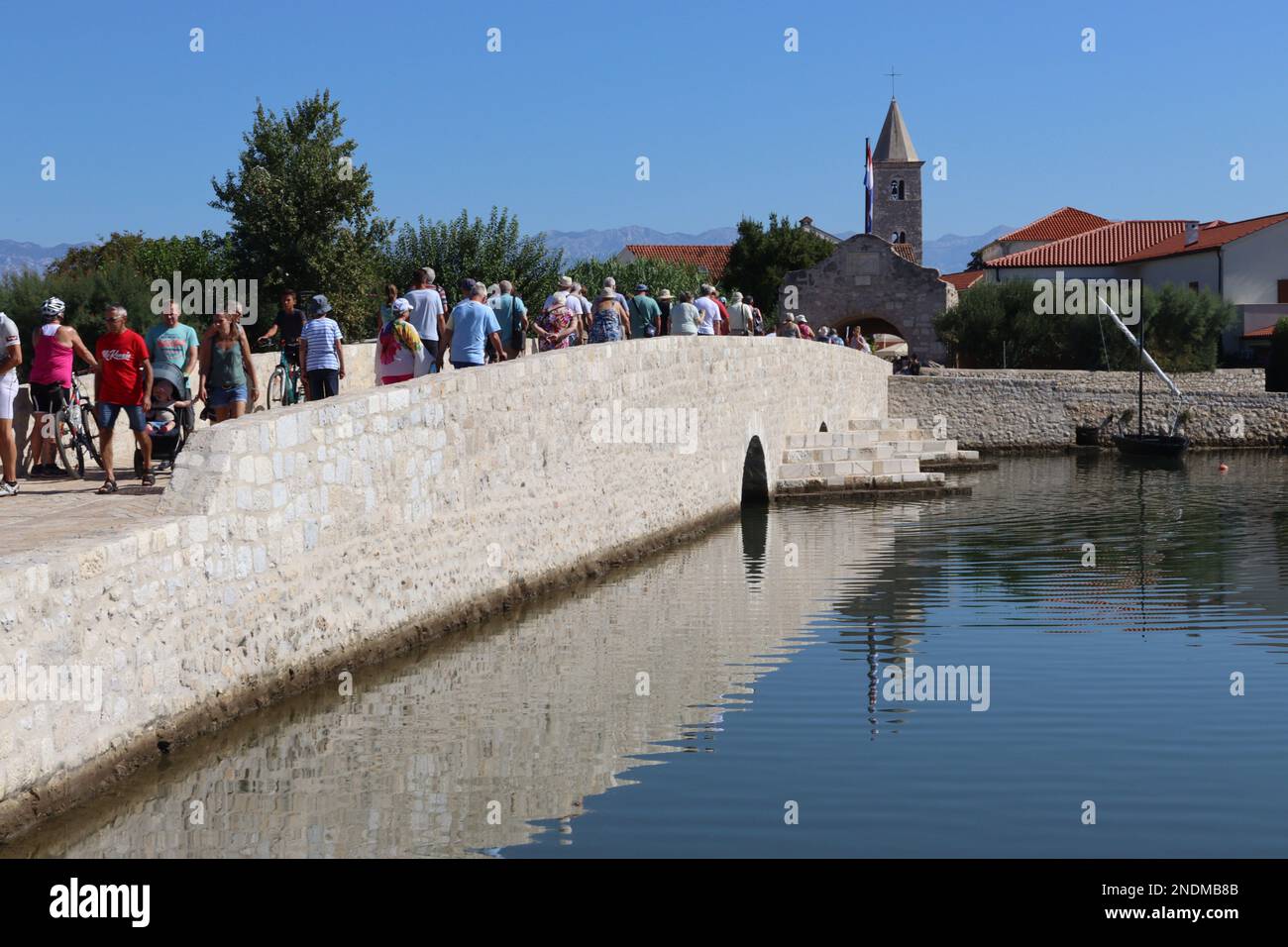 Visitors walk across the original 16th century access bridge to the ...
