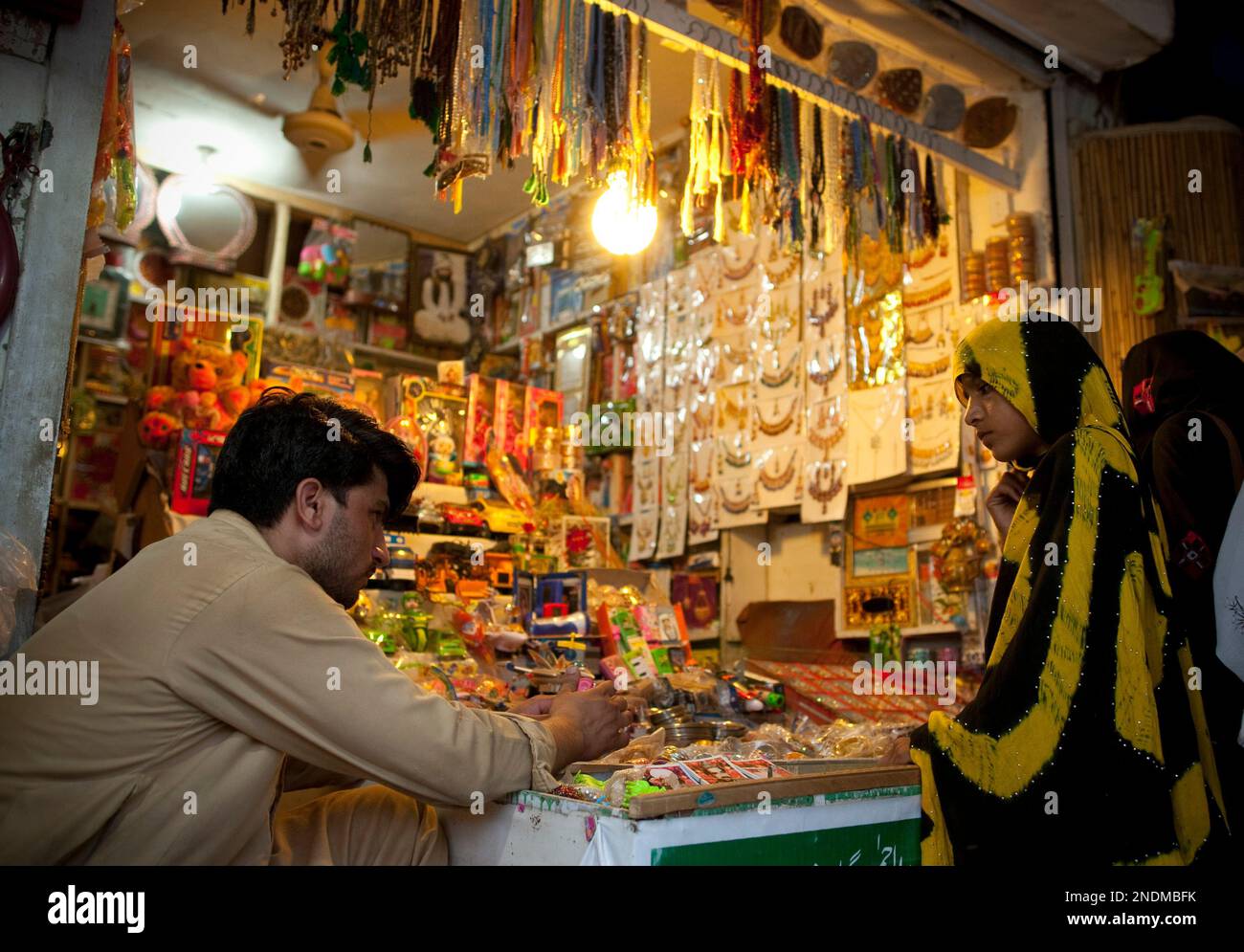 A Pakistani women shops at a store in outskirts of Islamabad, Pakistan ...