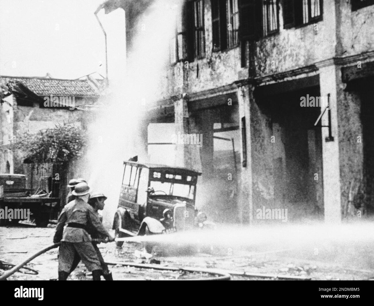 Firemen fighting a blaze caused by incendiary bombs dropped in the ...