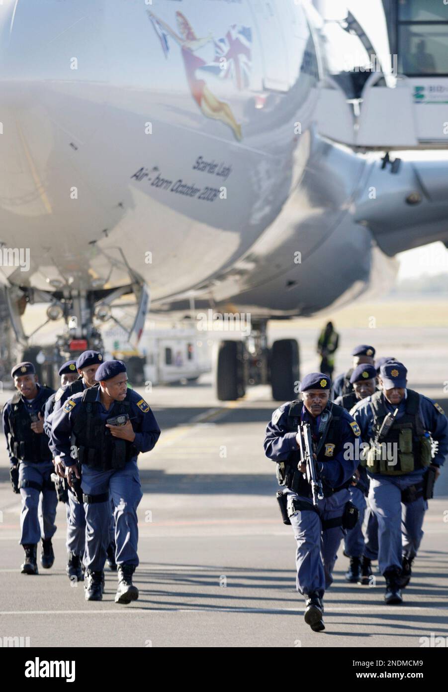 South African special police force run underneath an airplane during ...
