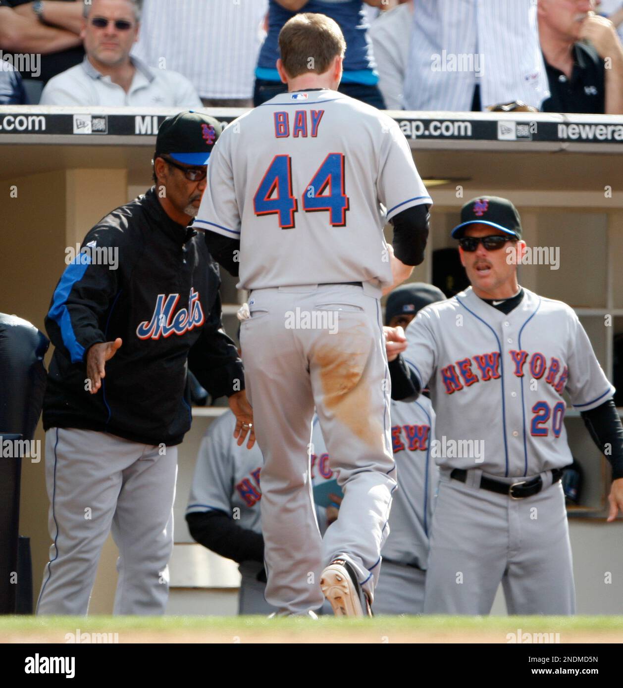 New York Mets' Jason Bay is met by manager Jerry Manuel, left, and ...