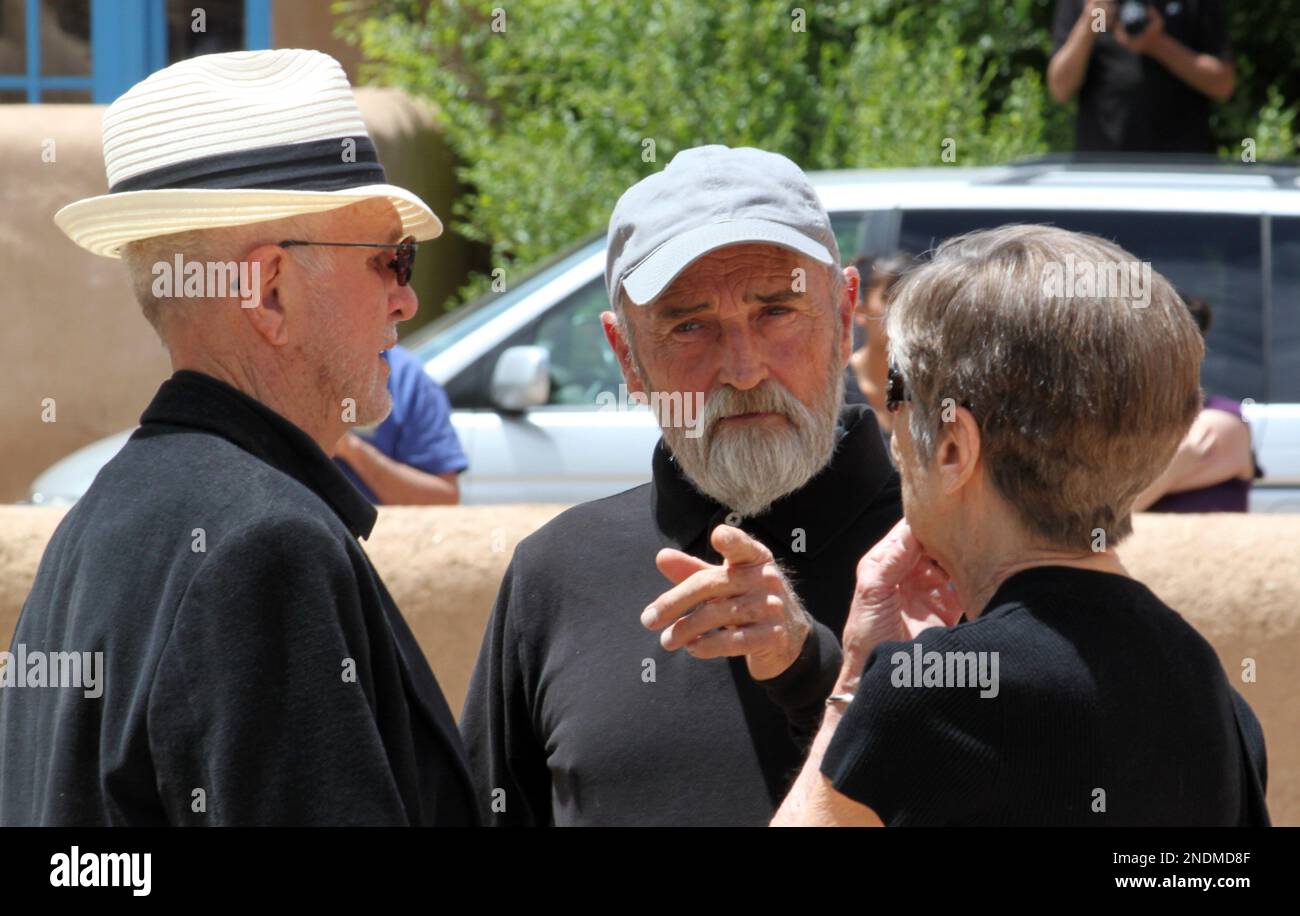 David Hopper, center, talks to friends before a memorial service for ...