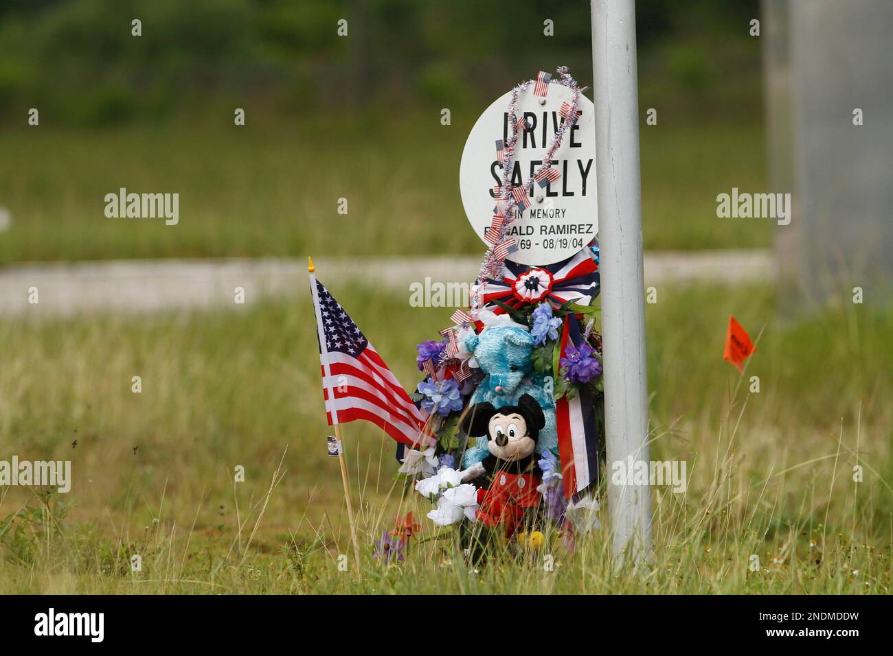 A Mickey Mouse doll, plastic flowers and an American flag decorate the ...