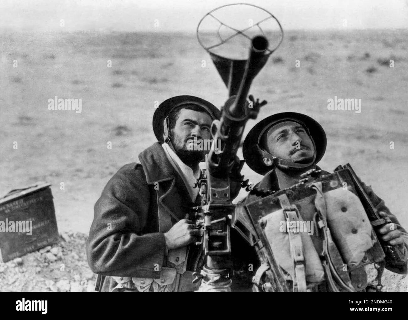 Two soldiers of the “Free French” armies man a captured Italian anti ...