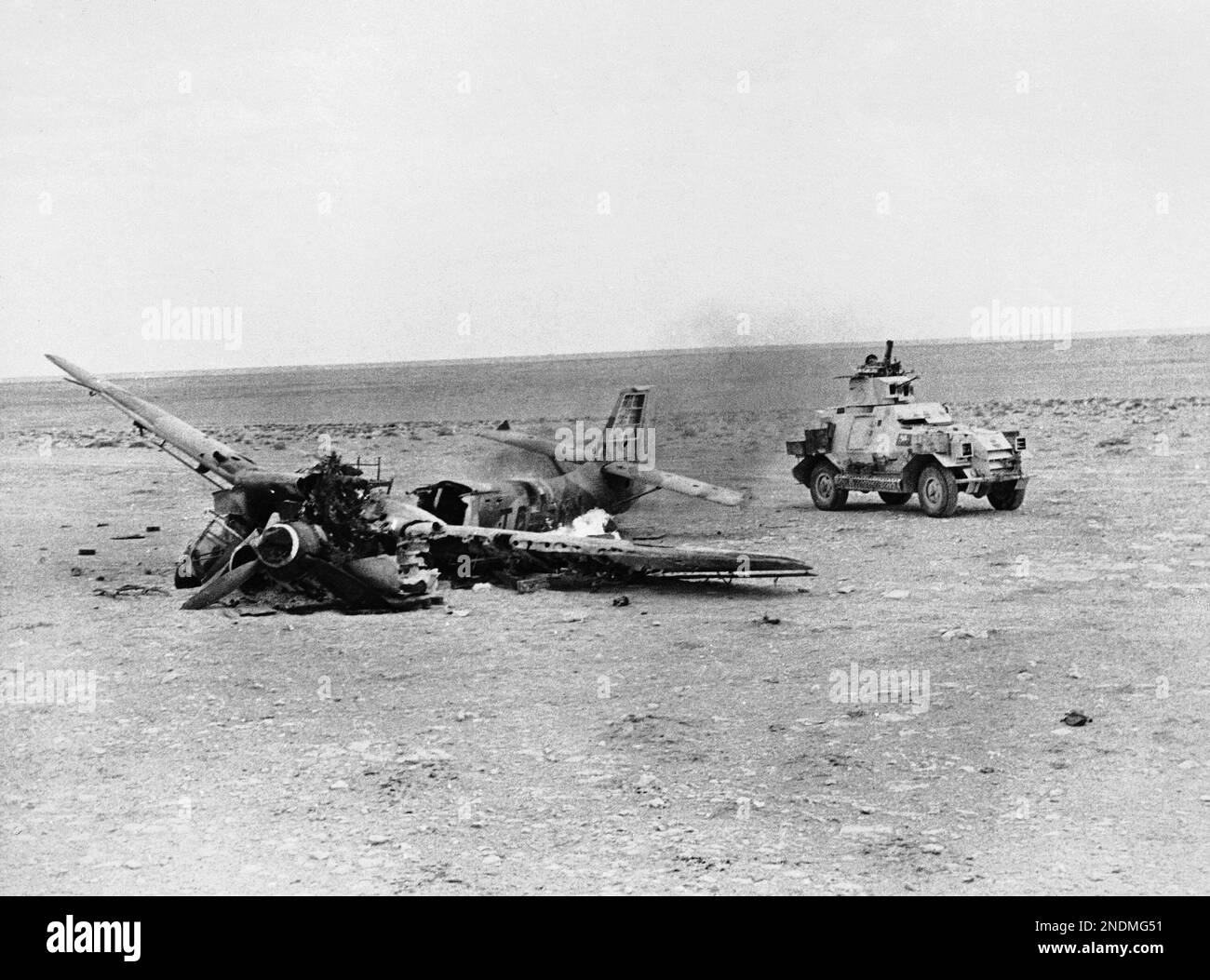 A South African armored car, right, rolls close to a German dive-bomber ...