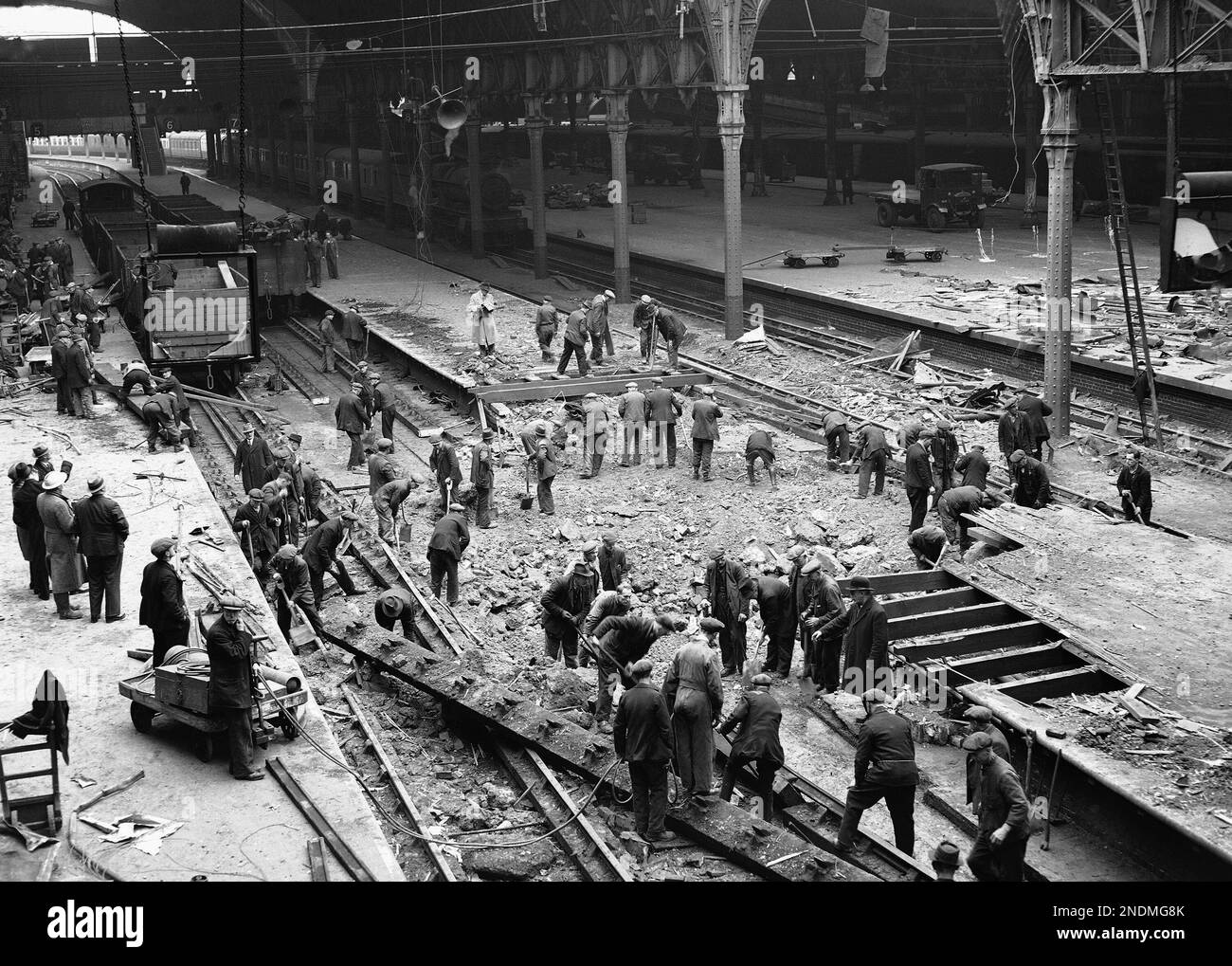 Workman clearing the debris and filling in the crater on platforms six ...