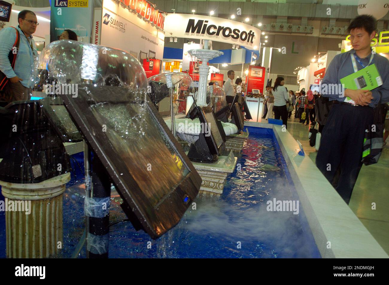 Visitors browse products displayed at the COMPUTEX 2010 Exhibition ...