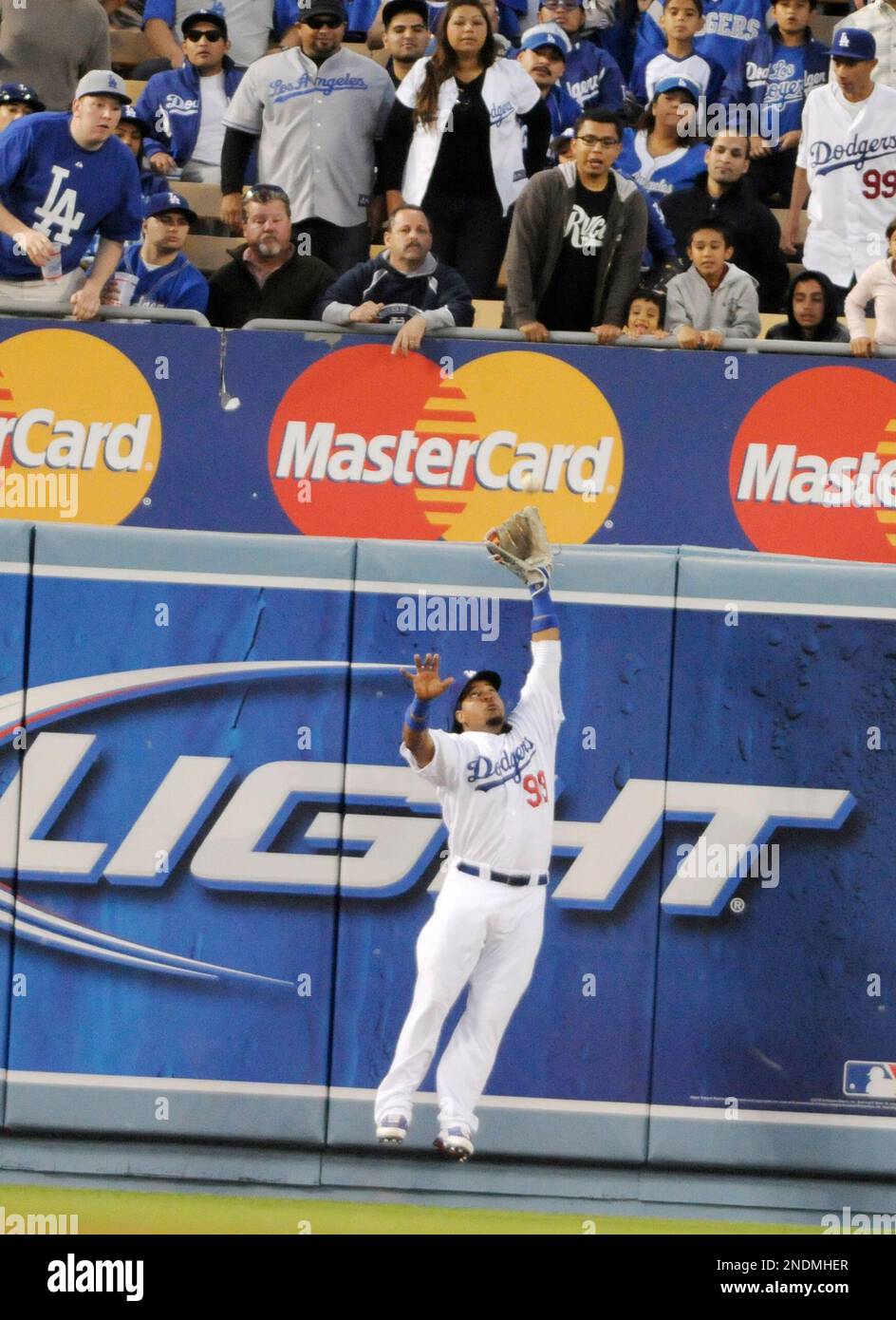 Los Angeles Dodgers' Manny Ramirez jumps to catch a fly ball at the ...