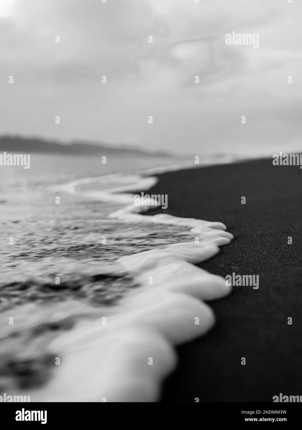 A grayscale of waves on a coast Stock Photo - Alamy