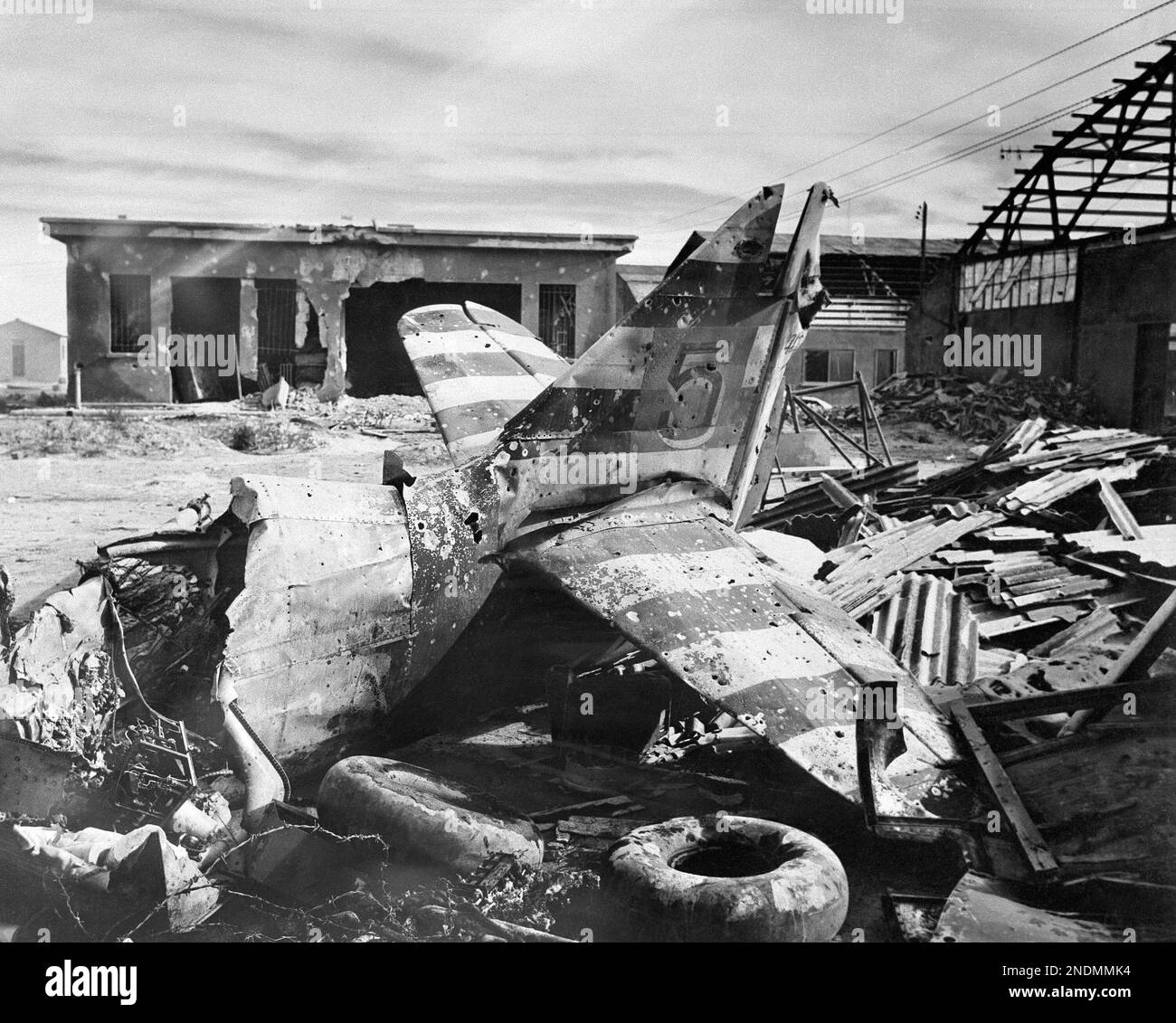 Bullet –riddled tail section of a French plane and rubble of shattered ...