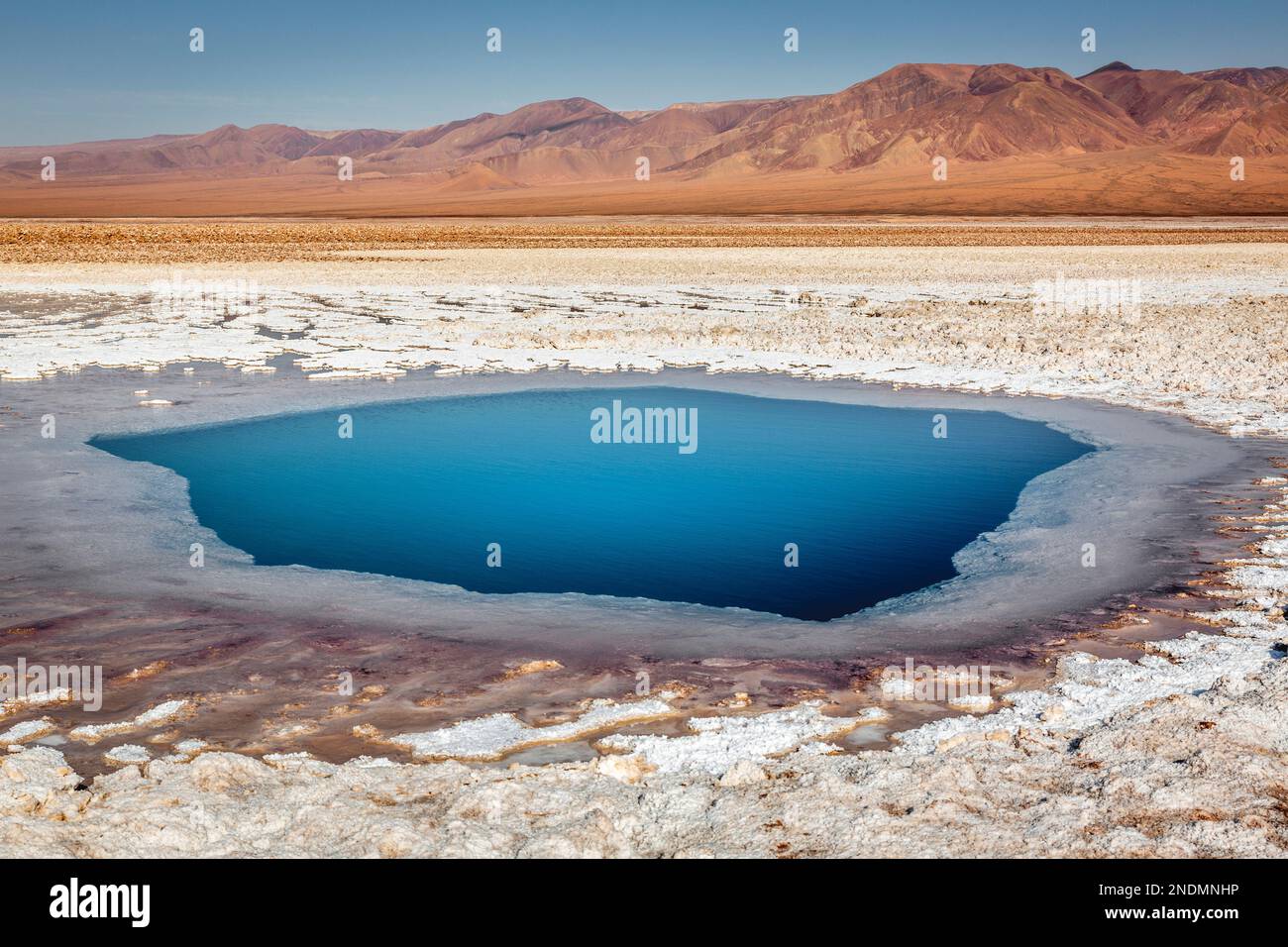 Salt lake reflection and idyllic volcanic landscape at sunrise, Atacama ...
