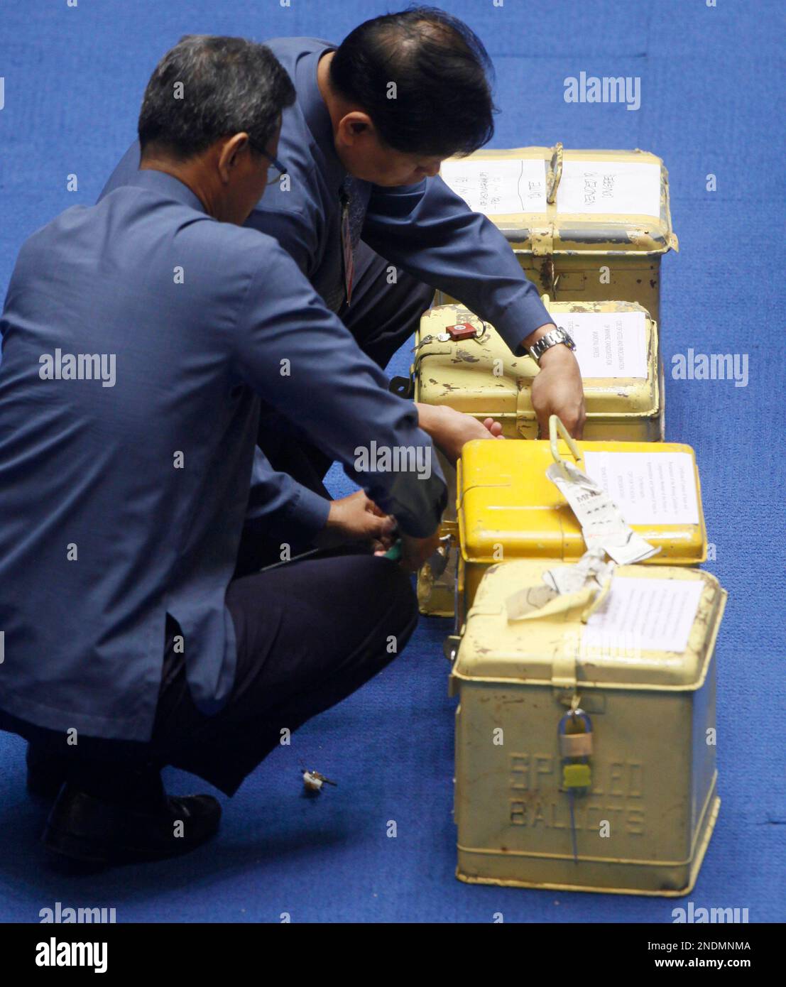 Staffers of the House of Representatives open ballot boxes containing ...