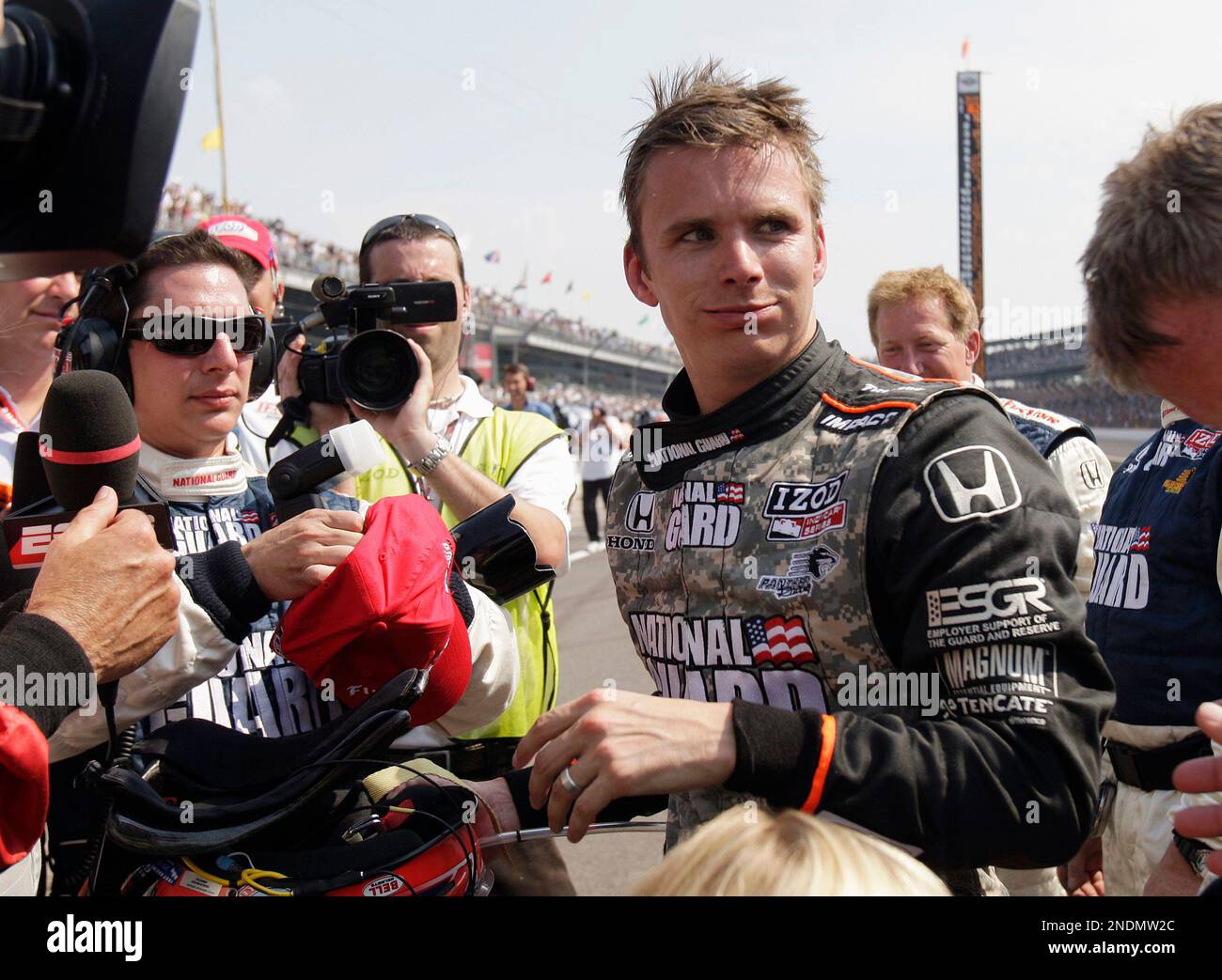 Dan Wheldon, of England, speaks with reporters after finishing in ...
