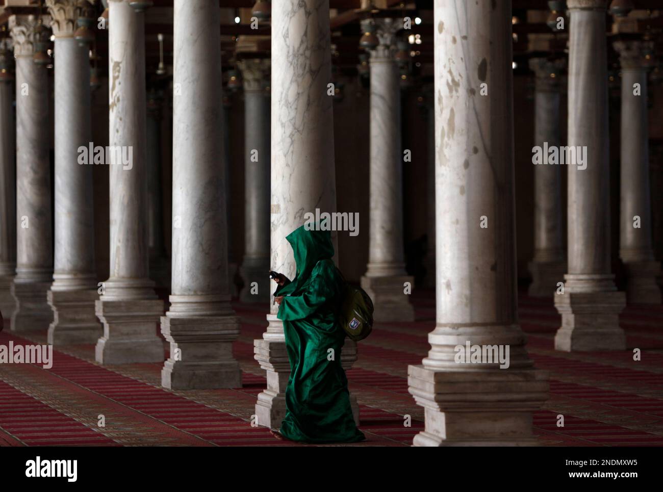 A foreign female tourist wears modest clothing covering her body ...