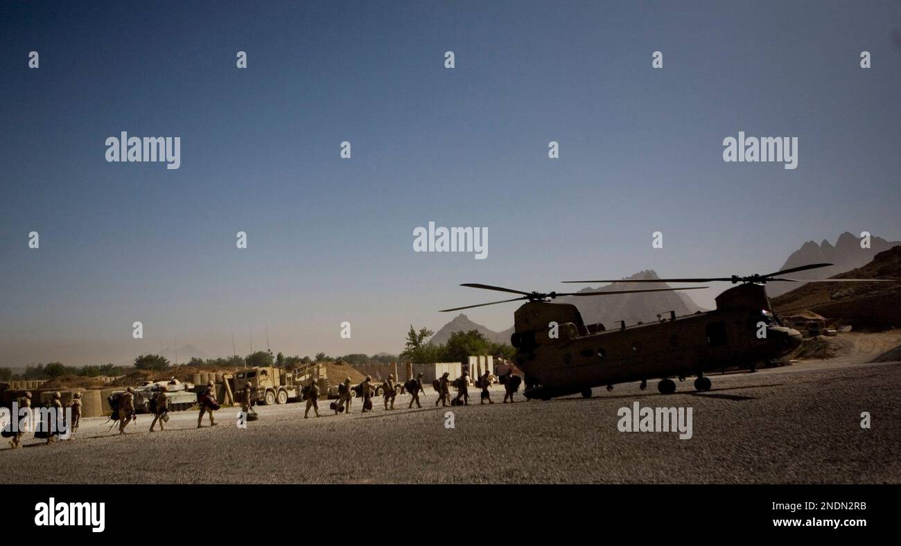 Canadian soldiers get on a helicopter before taking off from their FOB ...