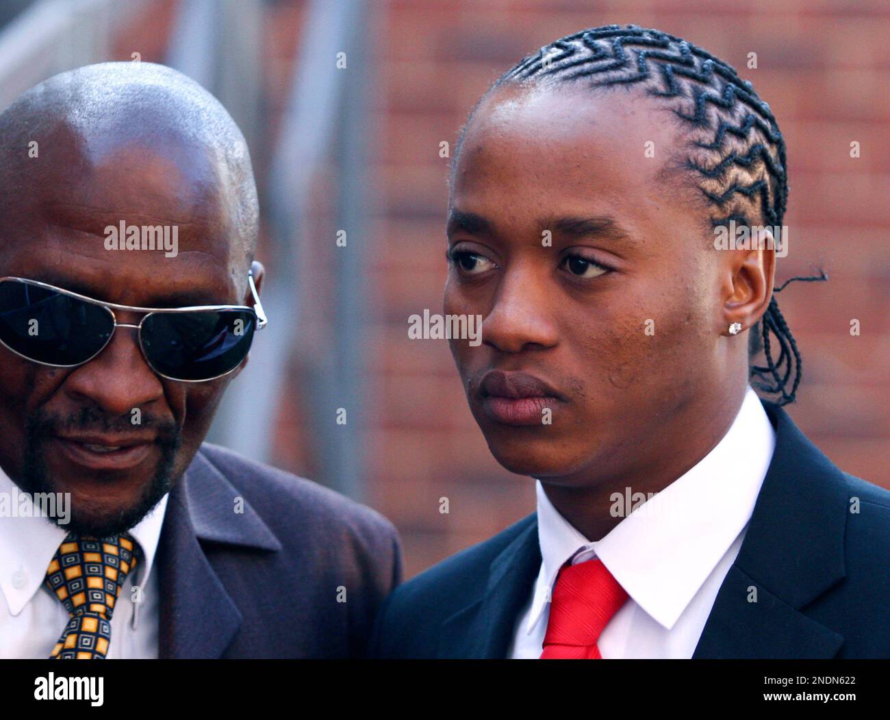 Hip hop star Jub Jub, right, appear outside the court in Soweto, South ...