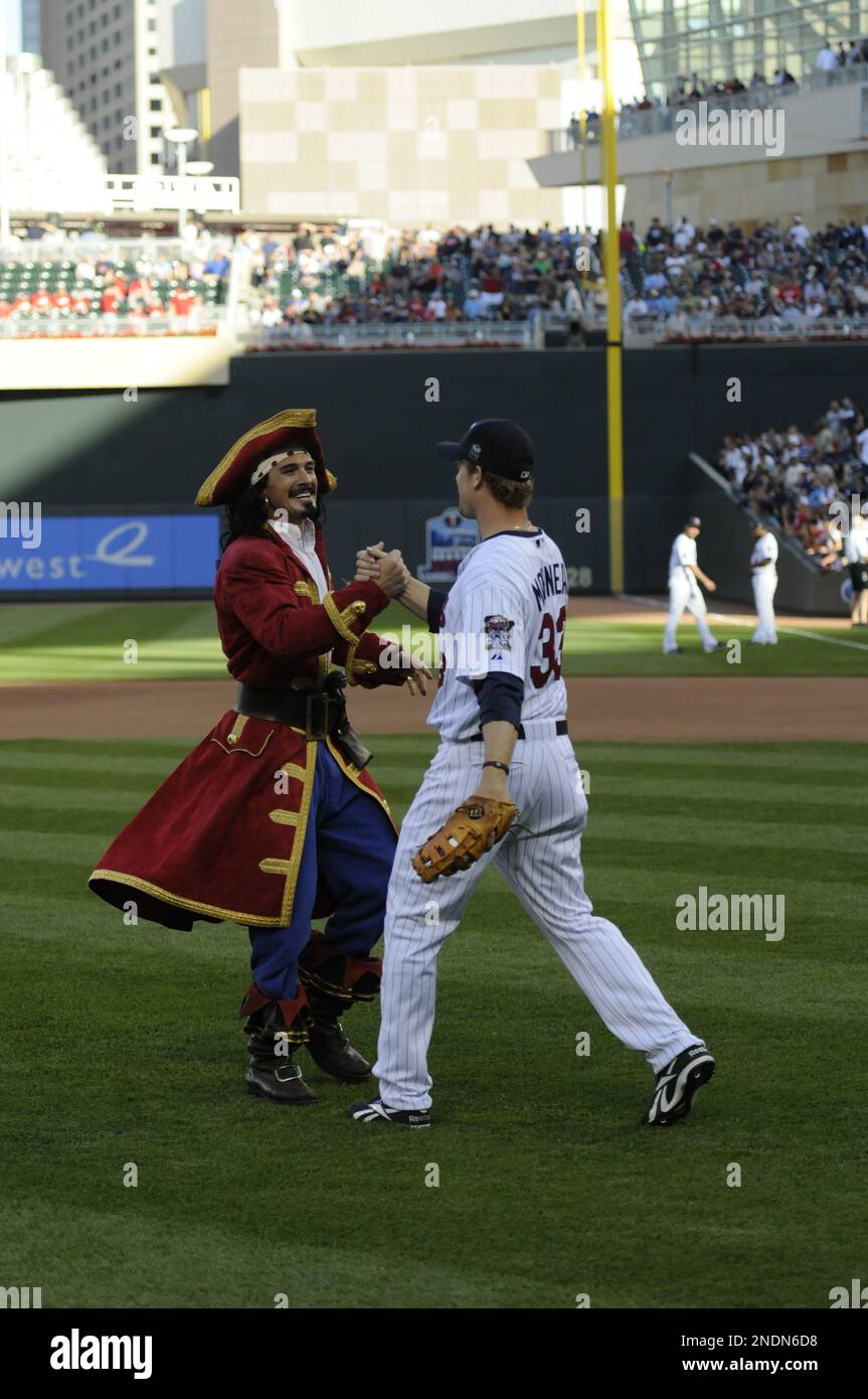 Captain Morgan shakes hands with Minnesota Twins Justin Morneau after ...