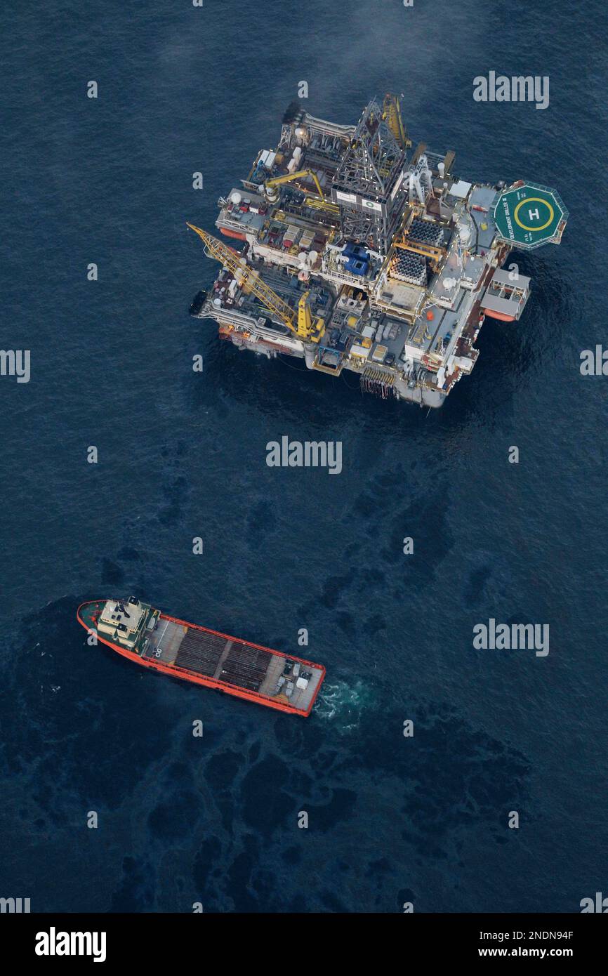 A rig drilling a relief well and support vessel are seen in the Gulf of ...