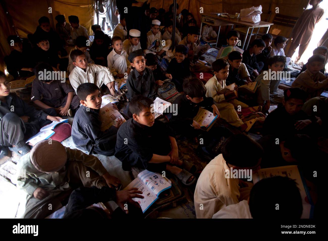 Pakistani students gather inside a tent serving as their makeshift ...