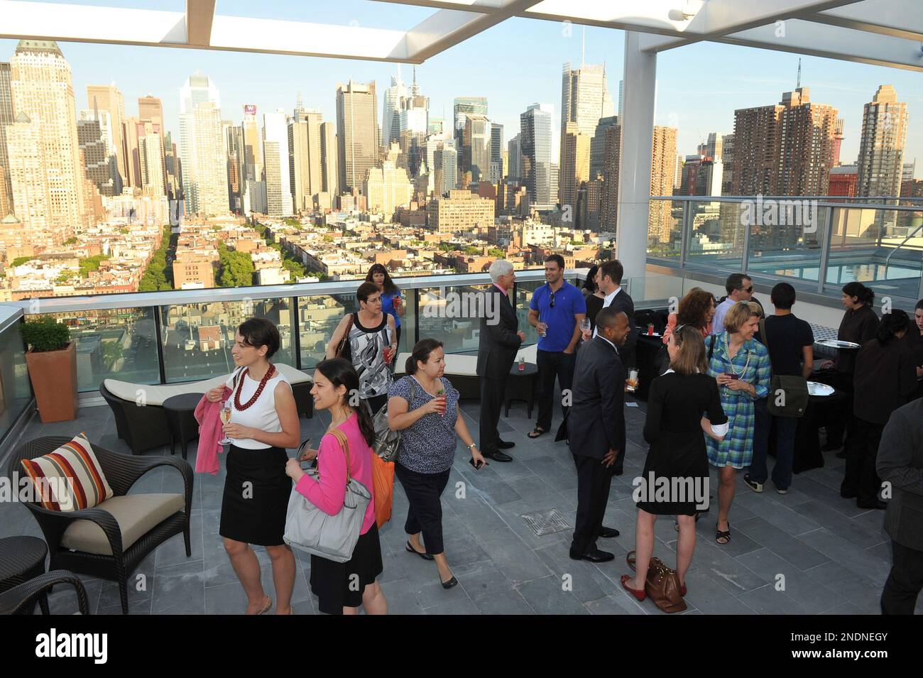Guests are photographed on a penthouse terrace during the official ...