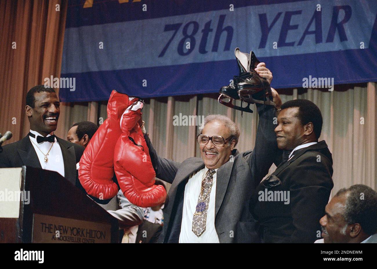 Dr. Benjamin Hooks, center, executive director of the NAACP, raises a ...