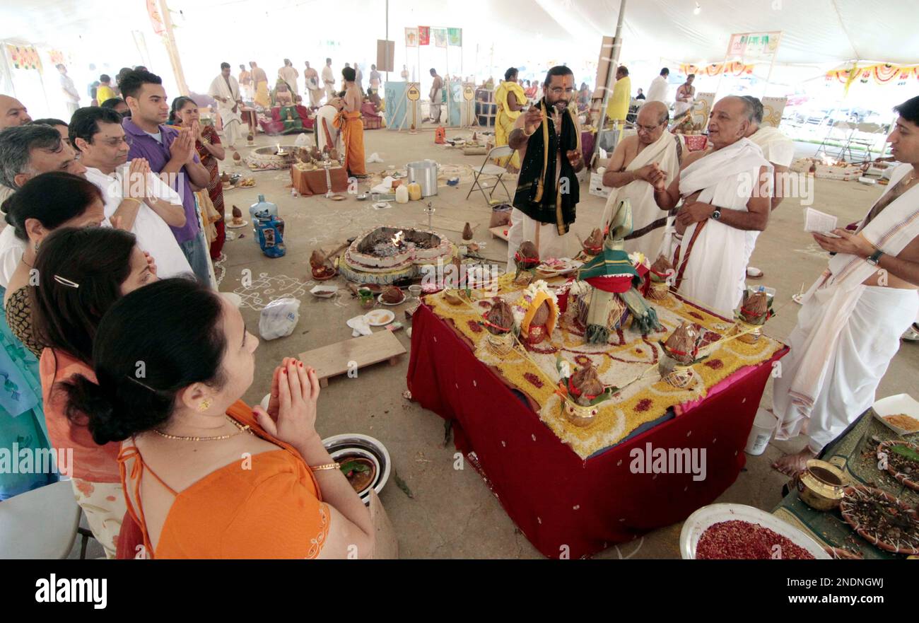 Visiting Hindu priests, right, perform a blessing as part of a ceremony ...