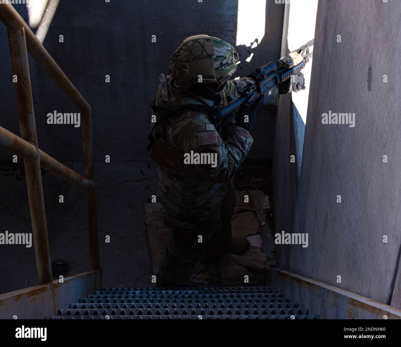 An Airman from the 22nd Security Forces Squadron guards a window while ...