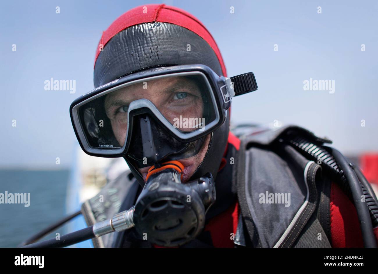 An archaeological diver prepares to plunge into the sea from the ...